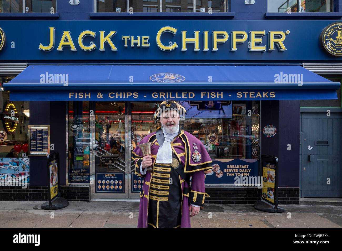London, UK 14 February 2024. A fully costumed professional town crier ...
