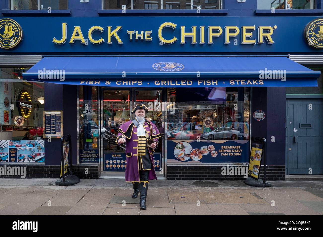London, UK 14 February 2024. A fully costumed professional town crier ...