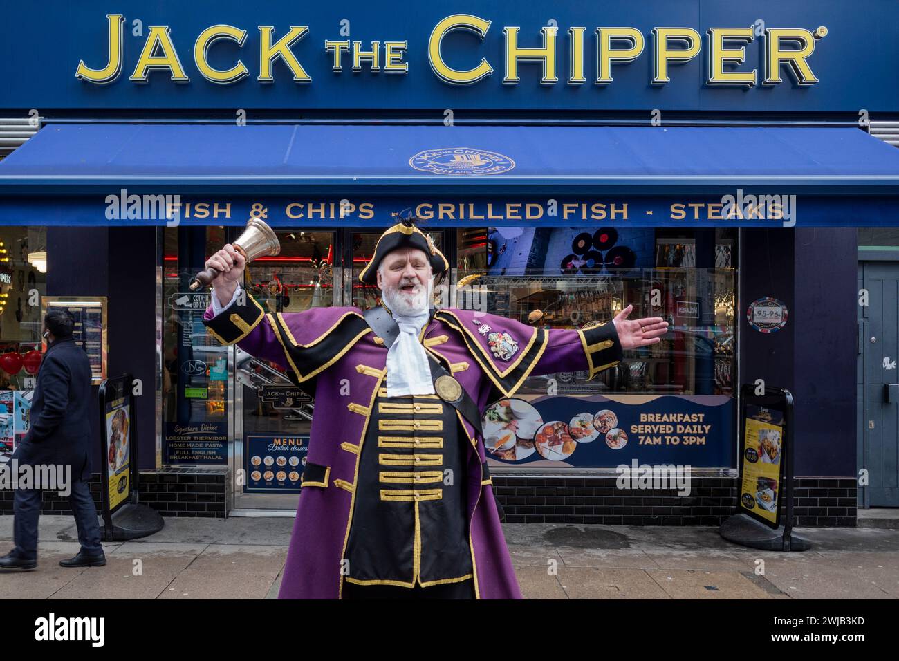 London, UK 14 February 2024. A fully costumed professional town crier ...