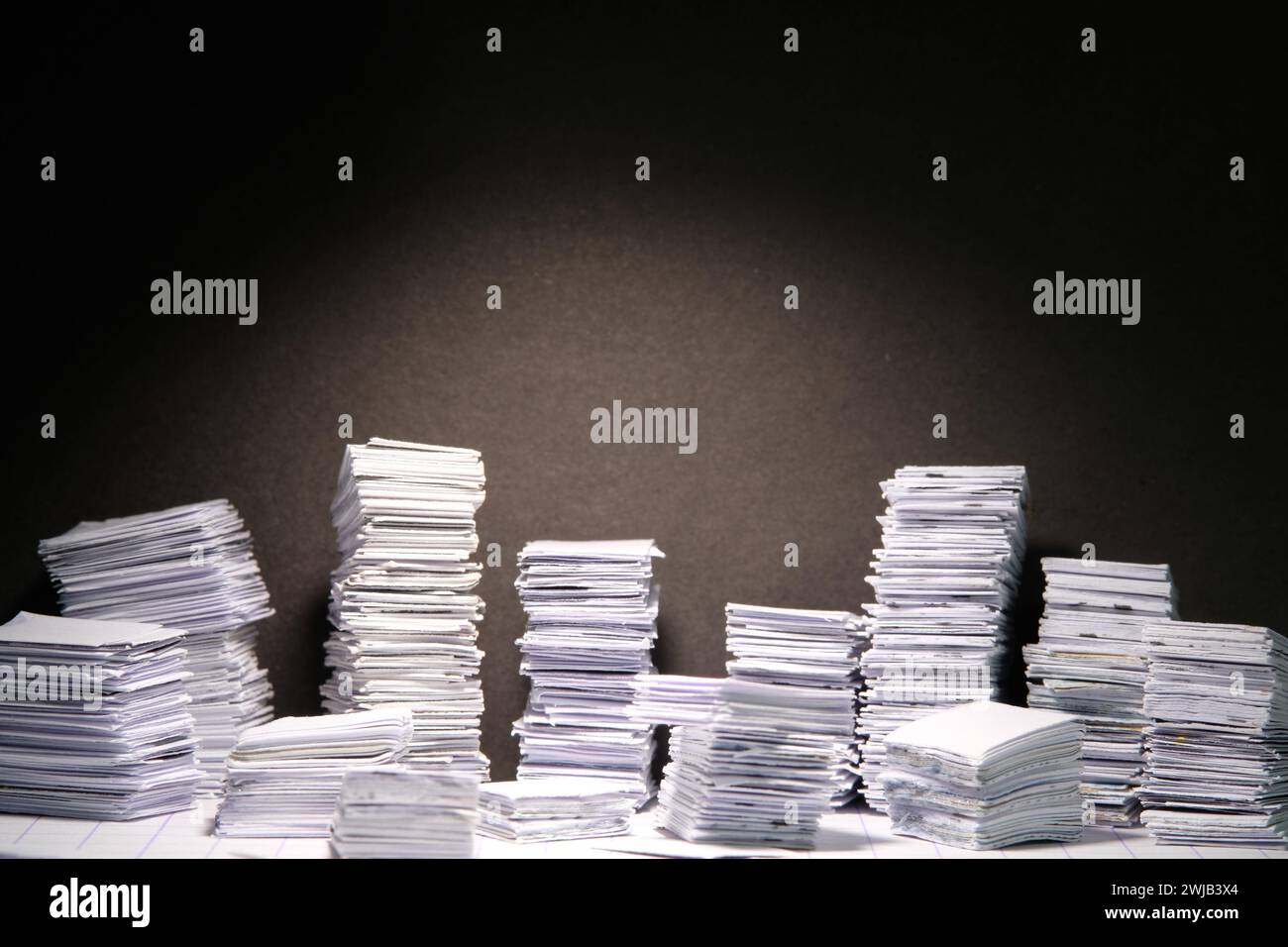 File, task, work flow management plan concept. A room full of piles of ...