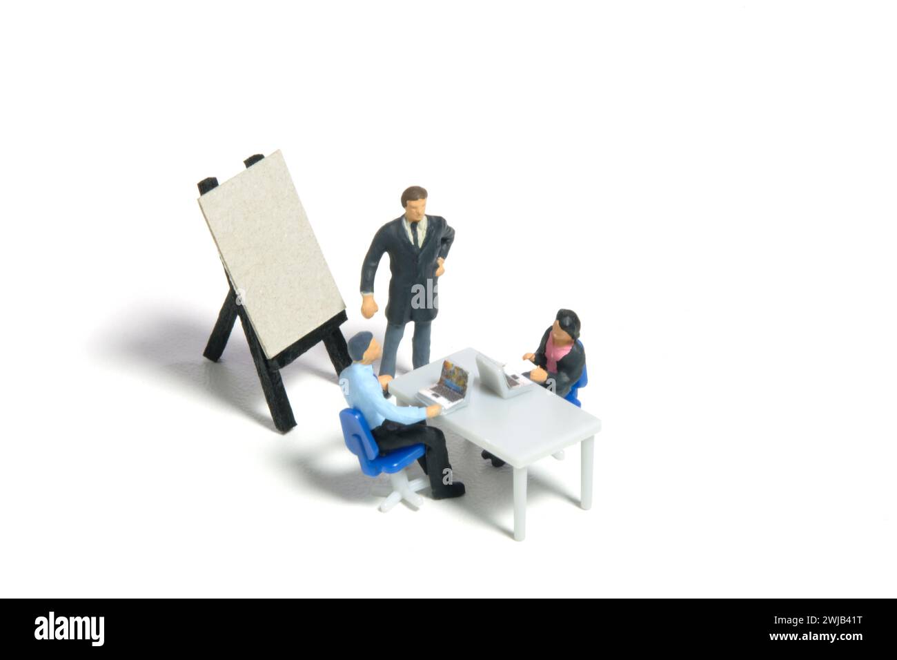 Miniature tiny people toy figure photography. Teamwork brainstorming ...