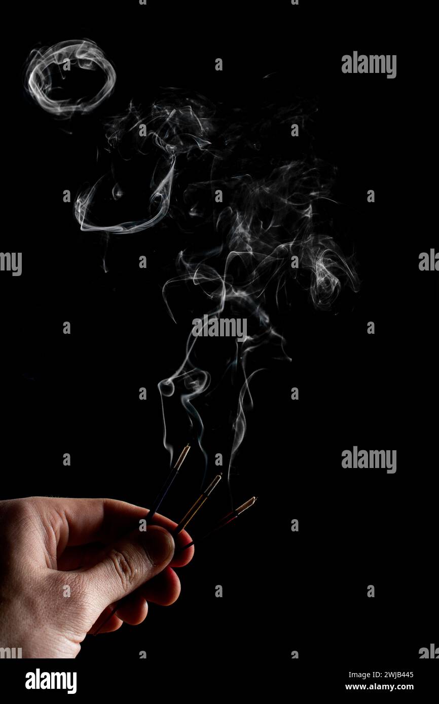 Two burning Incense Sticks with smoke on a black background. incense ...