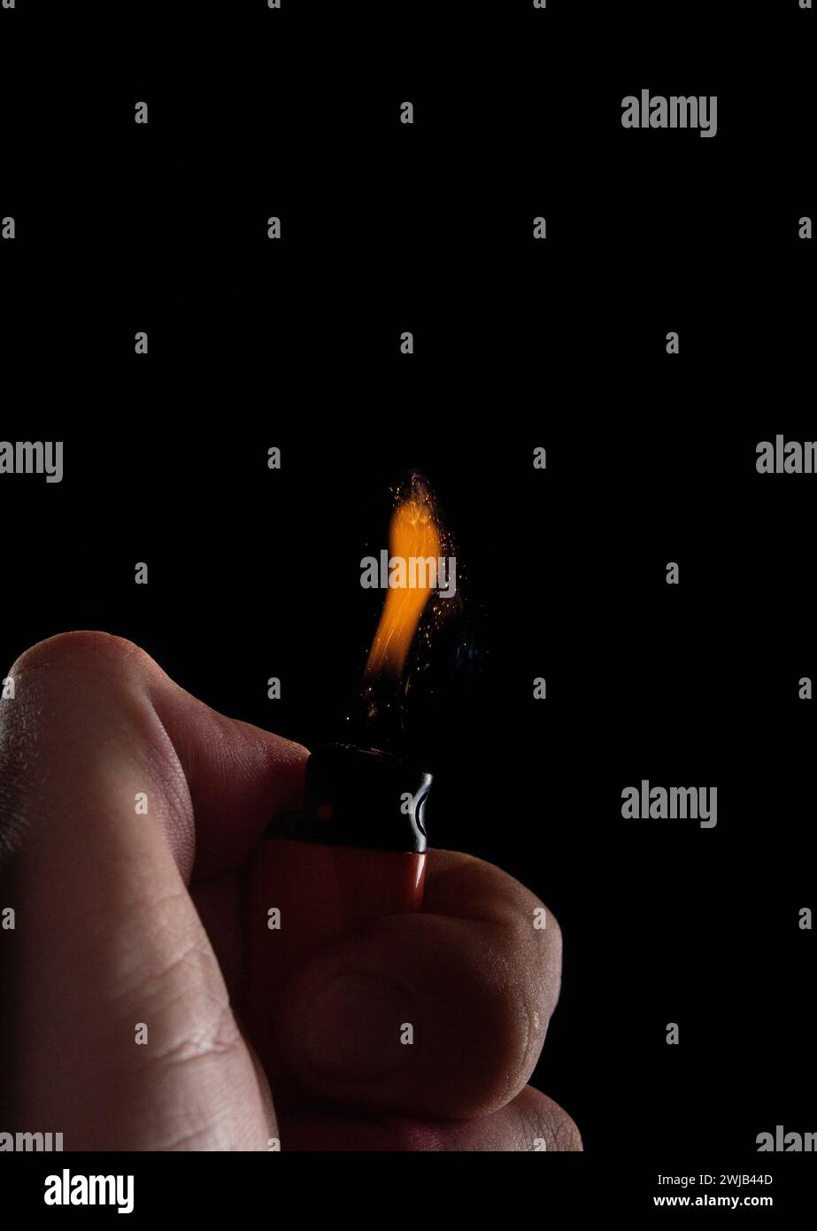 Hand with lighter igniting sparks Stock Photo - Alamy