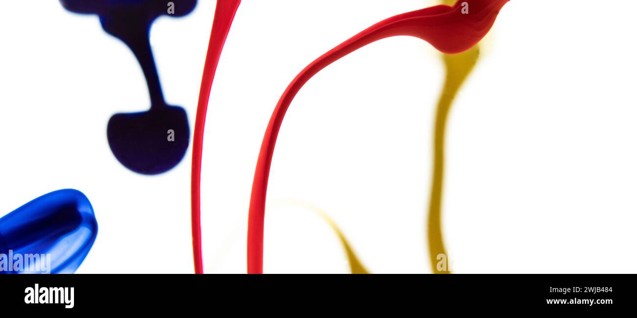 Colors dropped into liquid and photographed while in motion on white ...