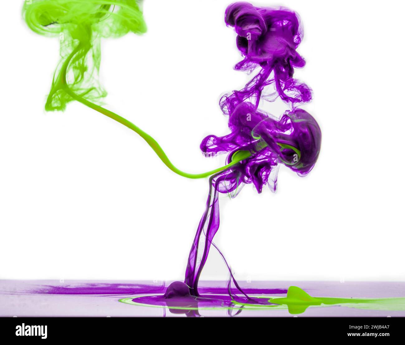 Colors dropped into liquid and photographed while in motion on white ...