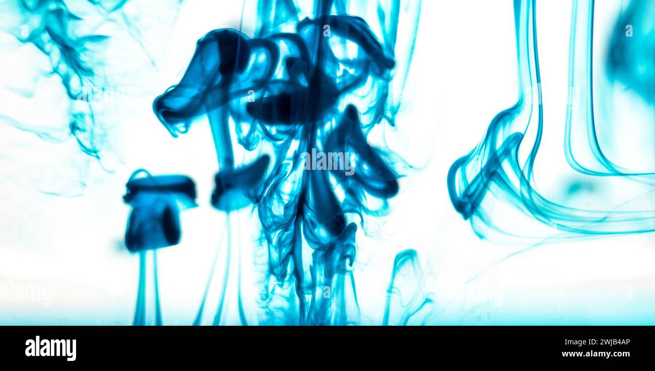 Colors dropped into liquid and photographed while in motion on white ...