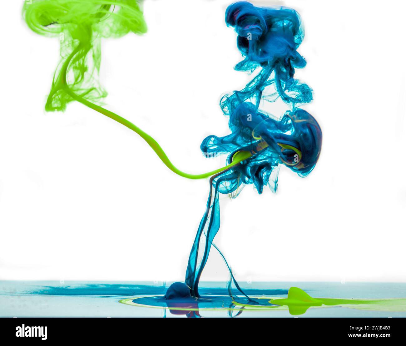 Colors dropped into liquid and photographed while in motion on white ...