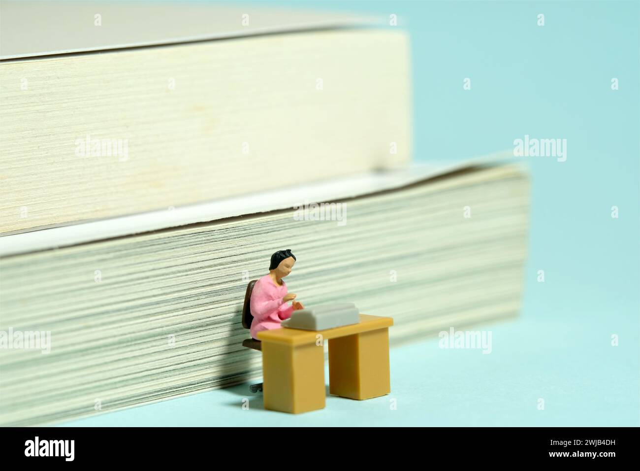 Miniature tiny people toy figure photography. Busy worker. A woman seat ...