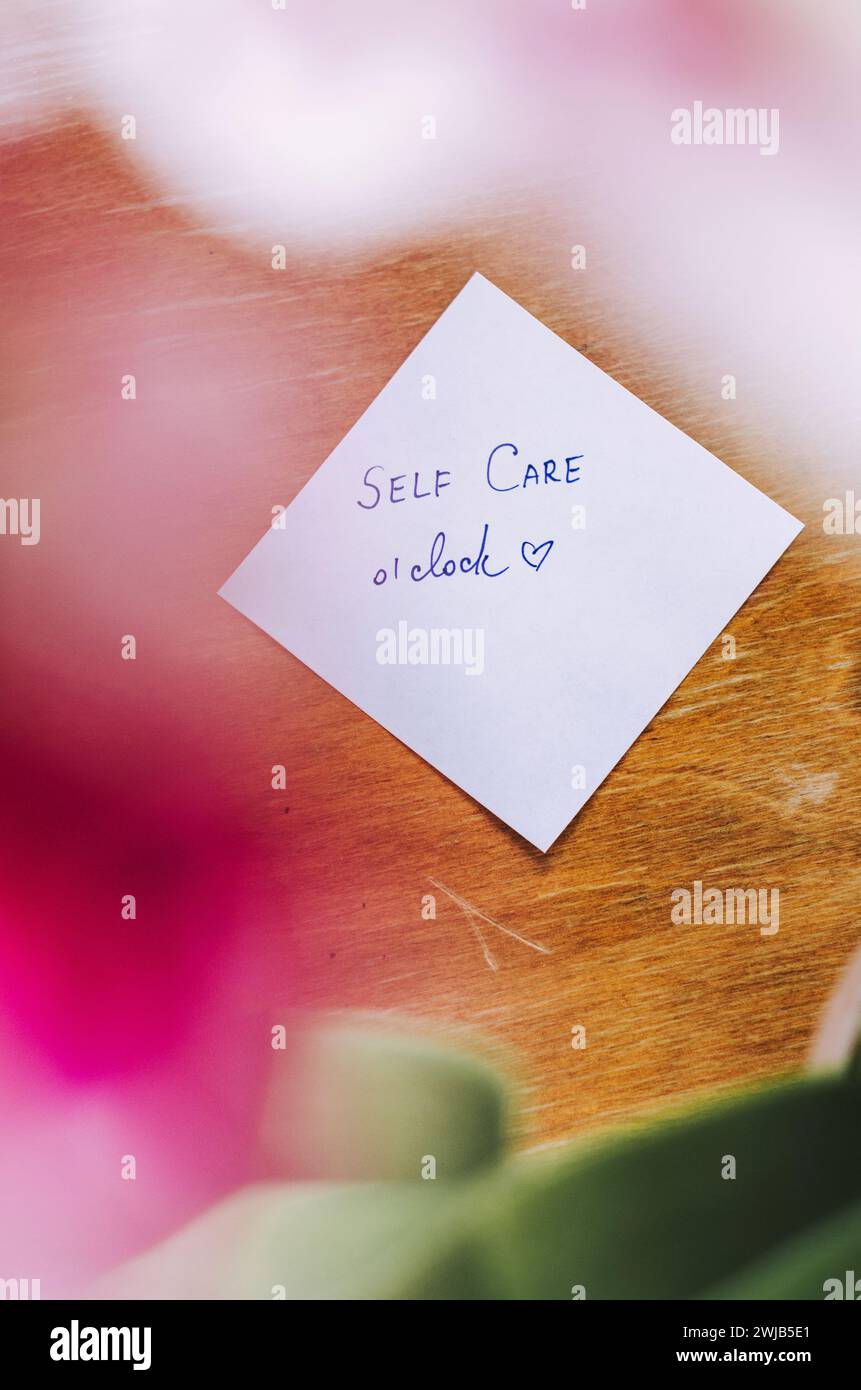 Self care o'clock message handwritten on post it Stock Photo - Alamy