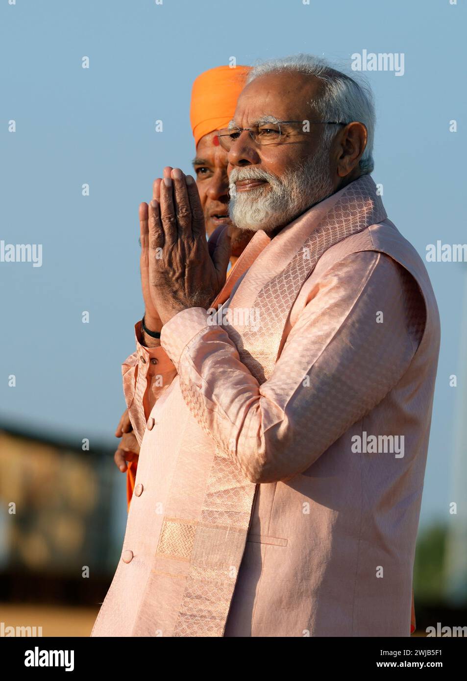 Indian Prime Minister Narendra Modi, front, greets people as he walks ...