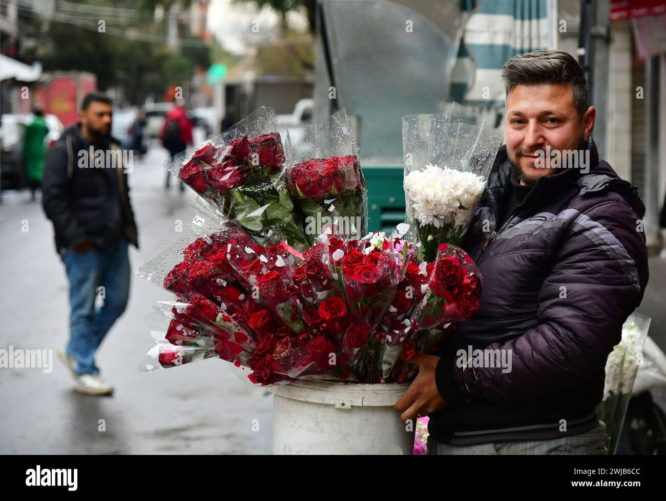 Damascus, Syria. 14th Feb, 2024. A vendor sells flowers on Valentine's ...
