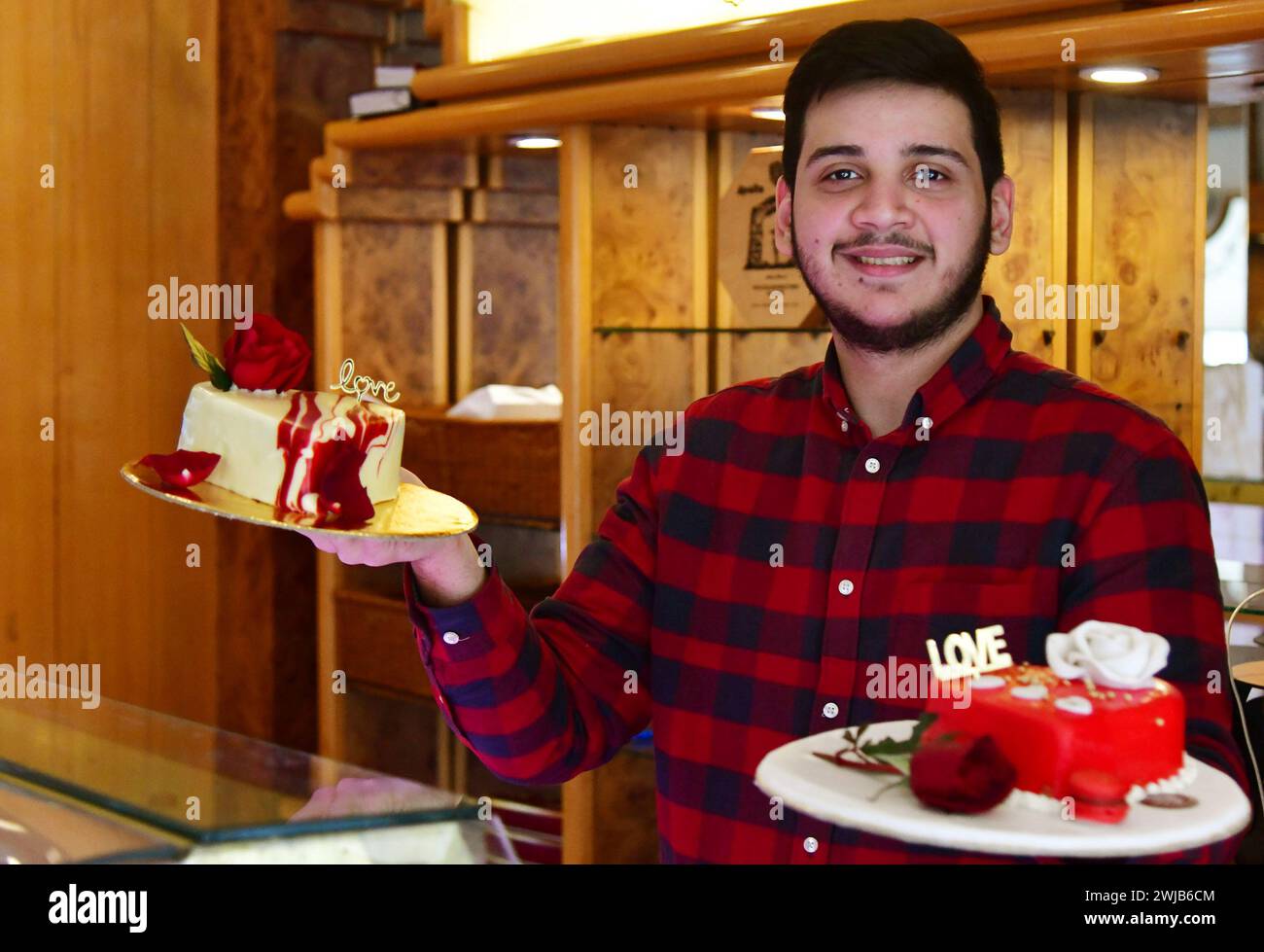 Damascus, Syria. 14th Feb, 2024. A vendor displays cakes for Valentine ...