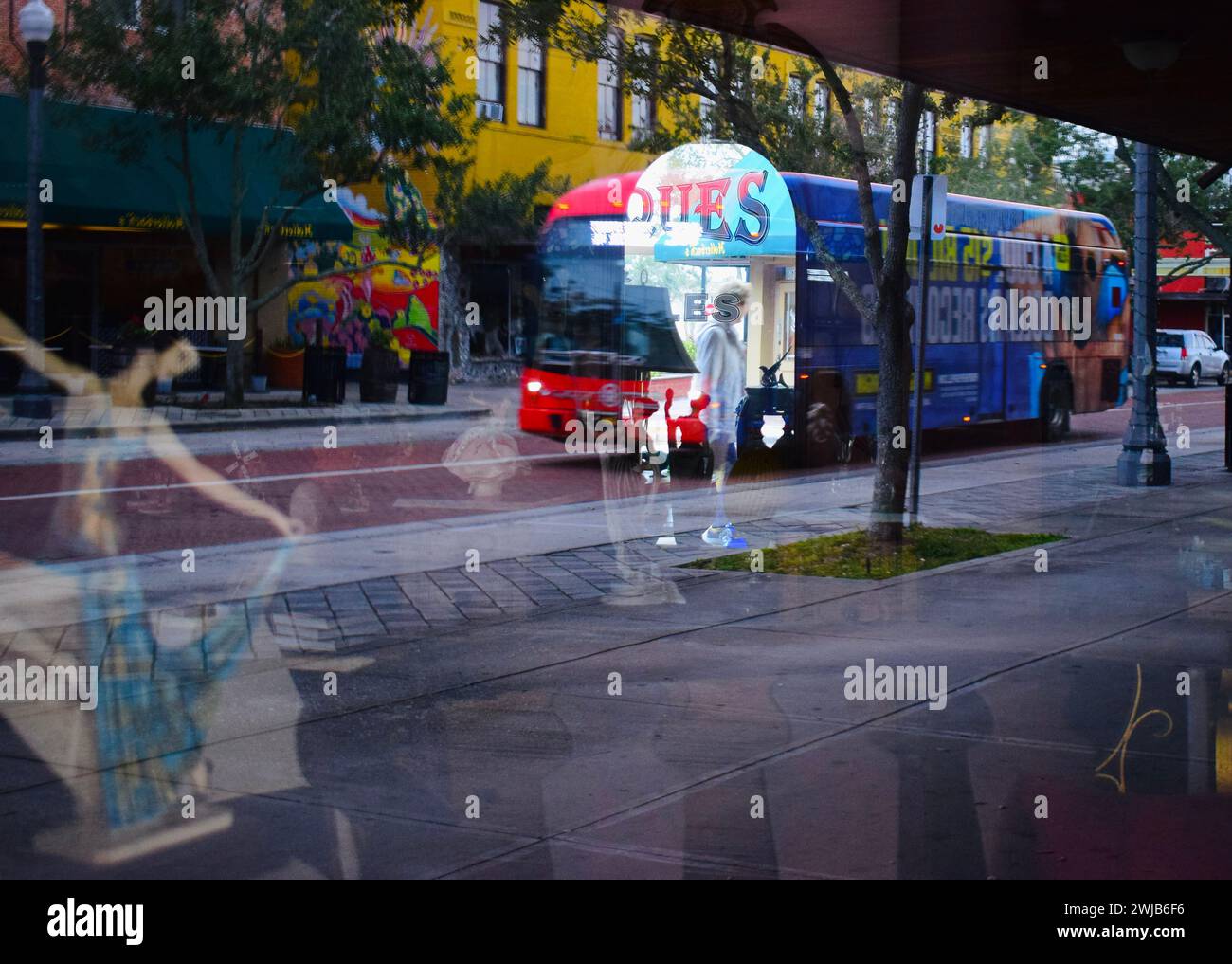 Reflections X3 store front window, mirror lady in bus Stock Photo - Alamy