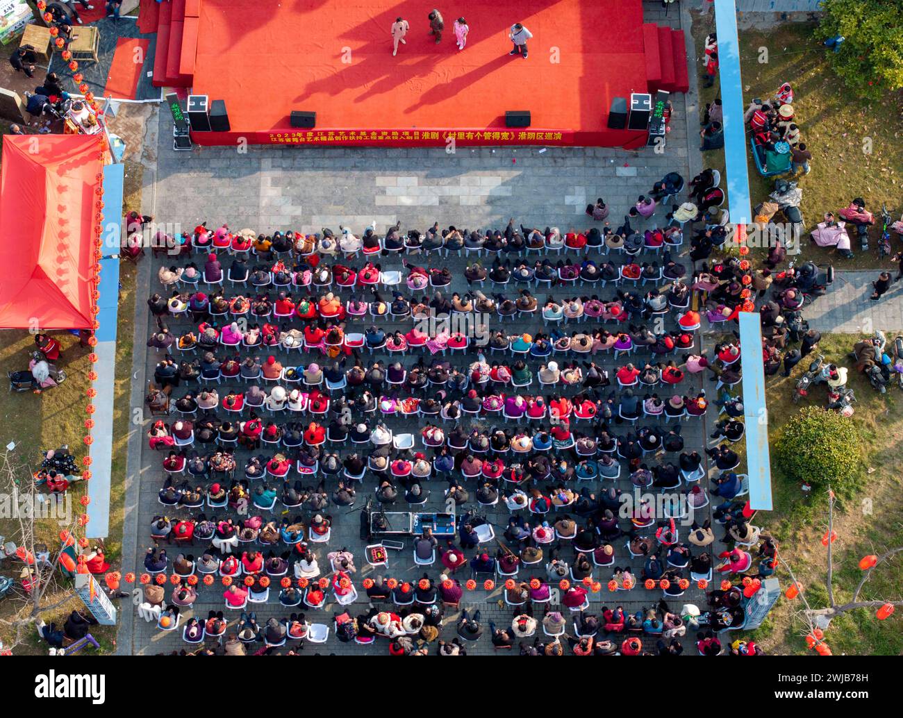 HUAI'AN, CHINA - FEBRUARY 14, 2024 - Villagers watch actors perform ...