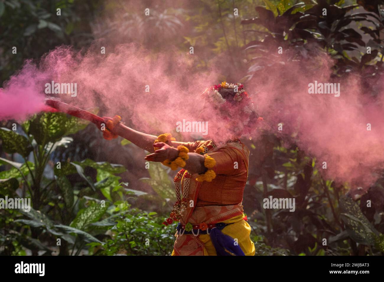 A woman seen blowing colour powder during Basanto Utsav the first day ...