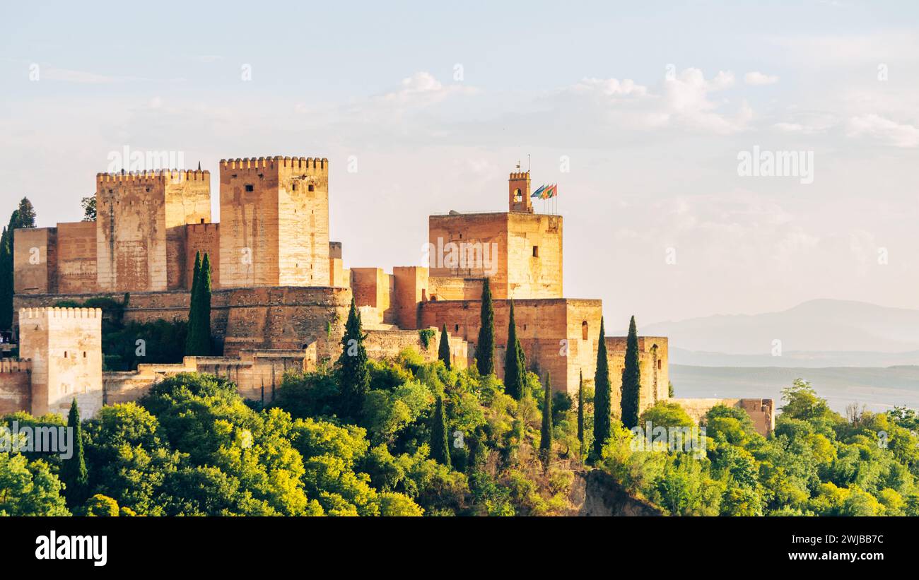 Alhambra palace with lush greenery and soft sunset light Stock Photo ...