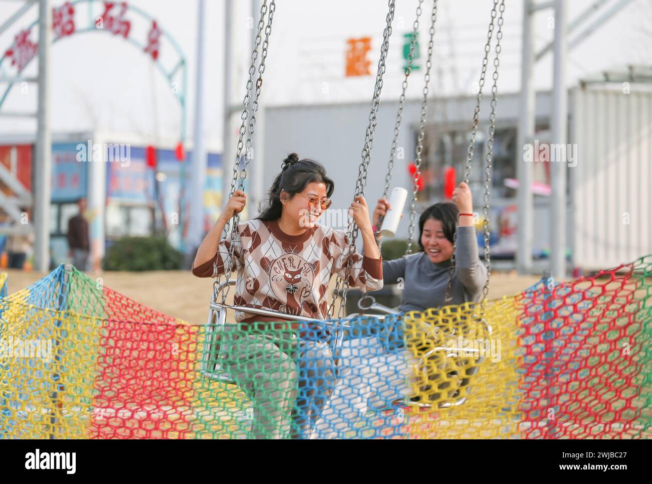 (240214) -- BEIJING, Feb. 14, 2024 (Xinhua) -- People have fun at a ...