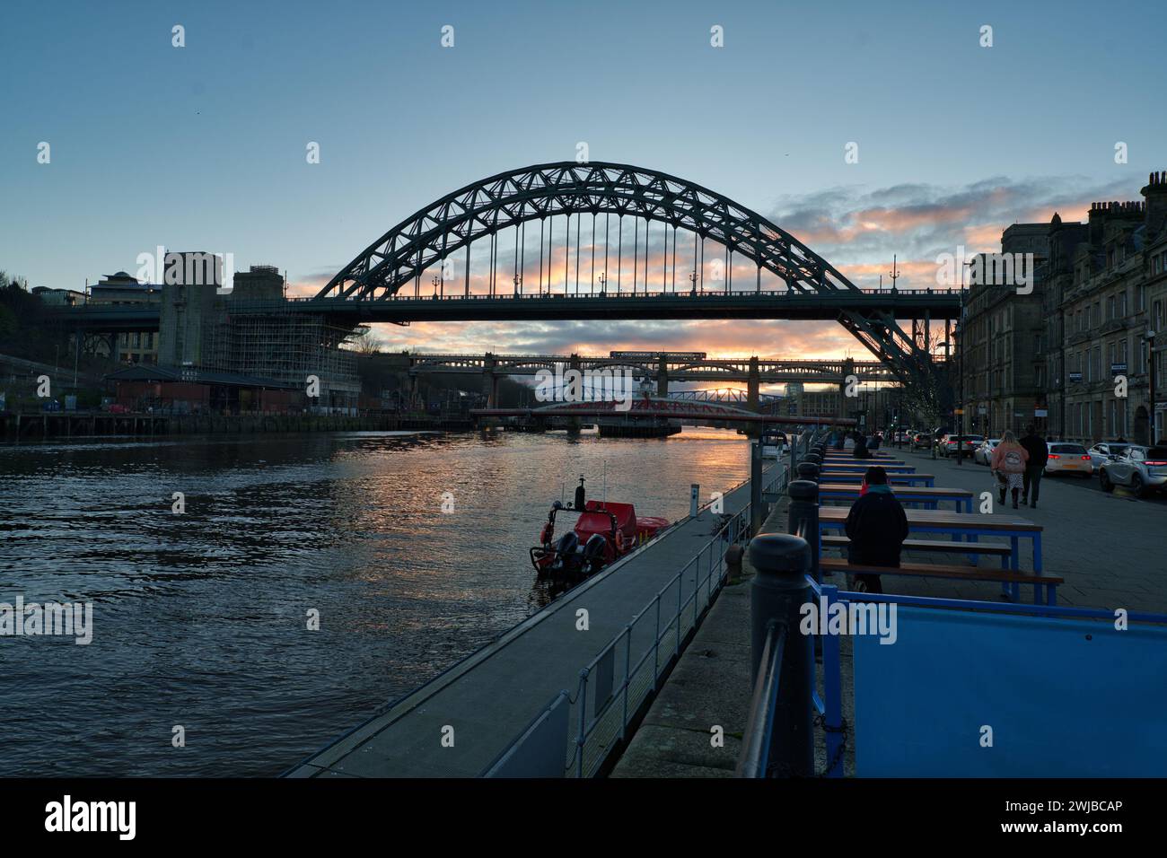 Newcastle River Tyne with the sun setting behind the Tyne Bridges, the ...