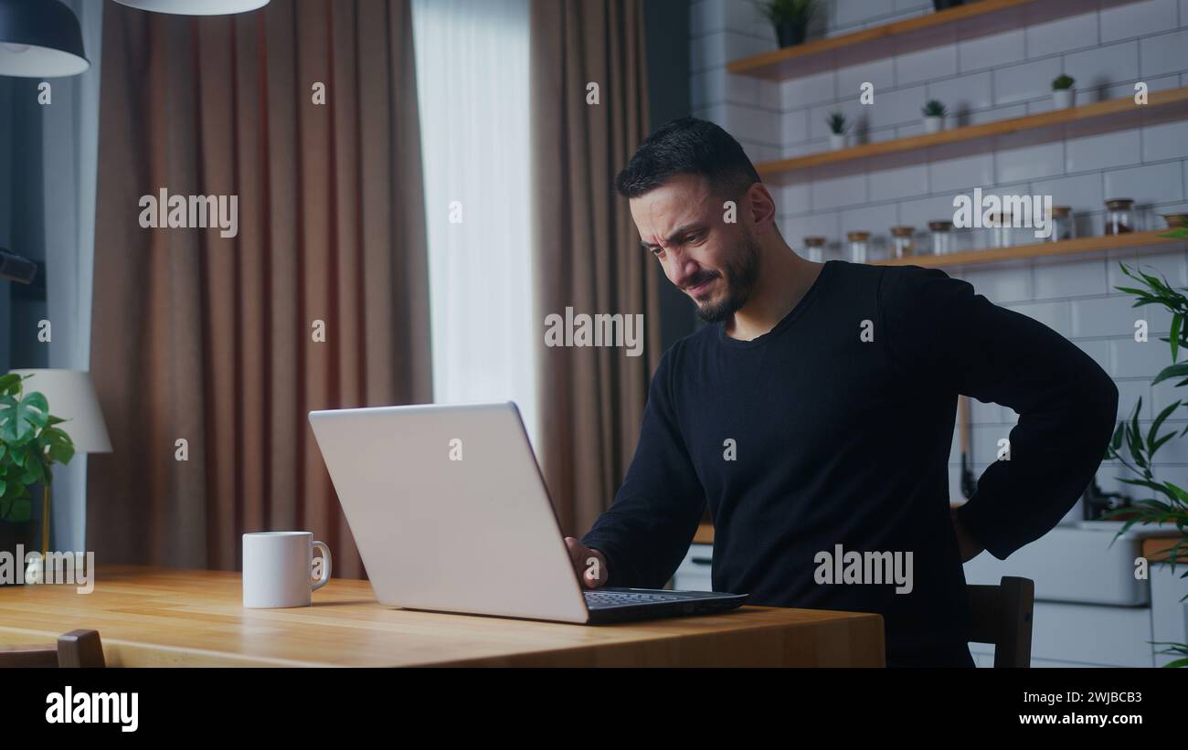 man sit in the kitchen experiences severe pain in neck and waist ...