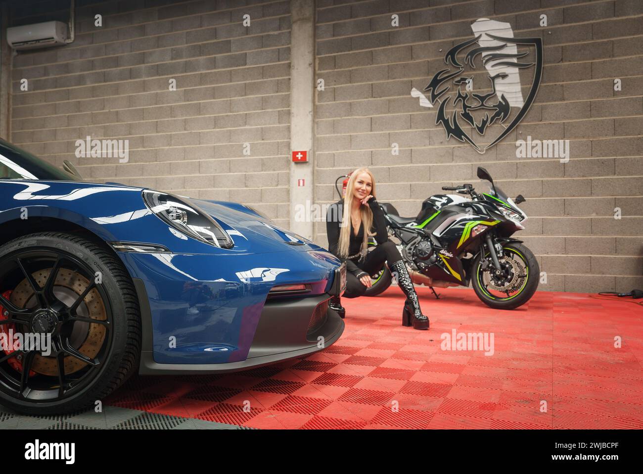 Luxury Cars, plus a Motorcycle and Model, Displayed in Swiss Showroom ...