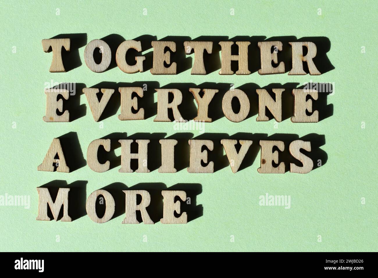 TEAM acronym for Together Everyone Achieves More in wooden alphabet ...