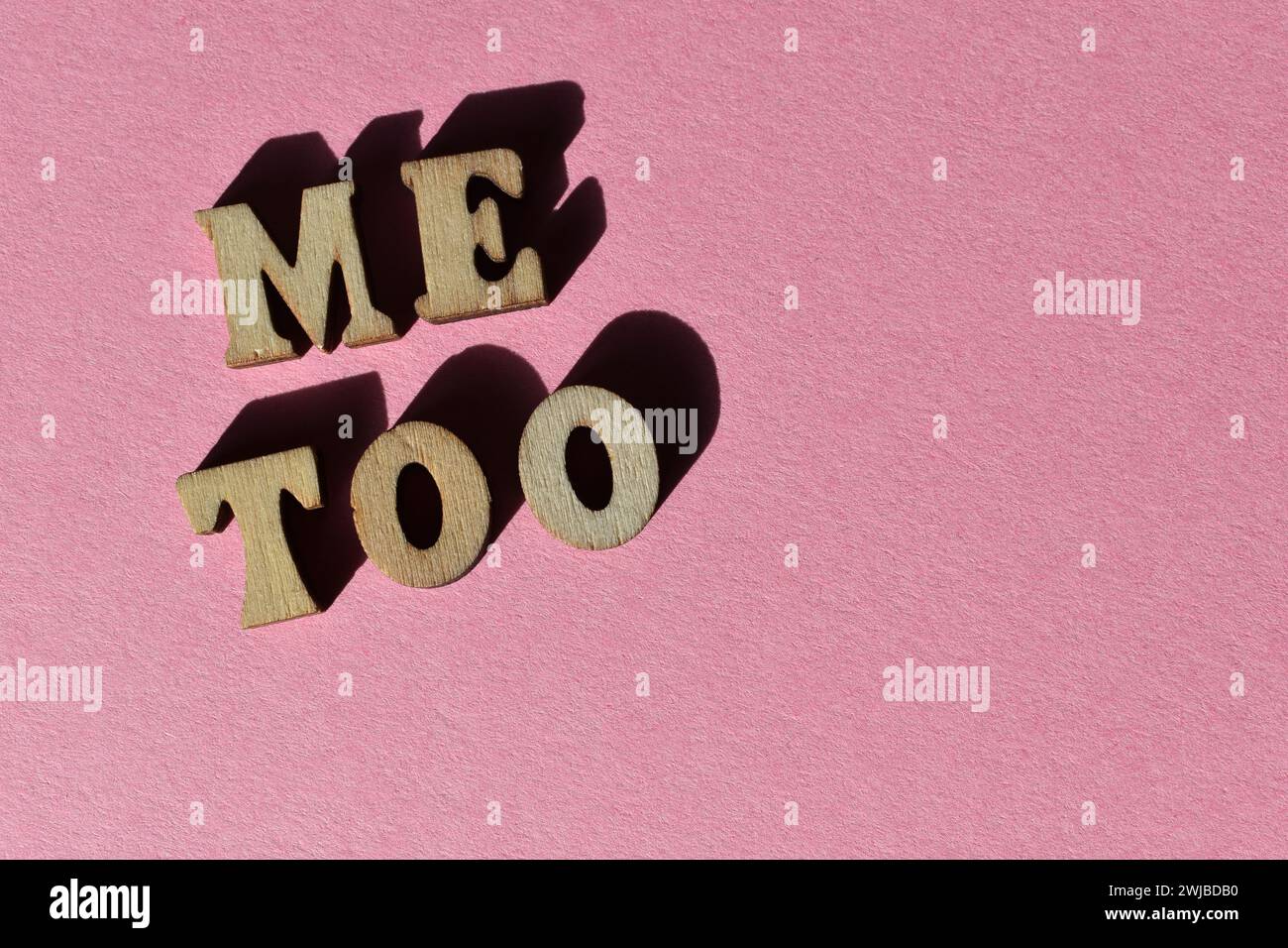Me Too, words in wooden alphabet letters isolated on pink background ...
