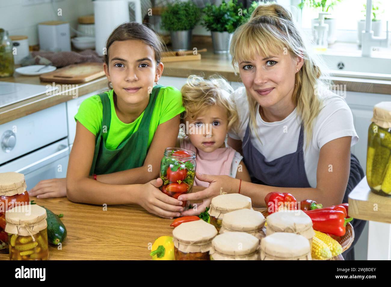 Family canning vegetables in jars in the kitchen. Selective focus Stock Photo - Alamy