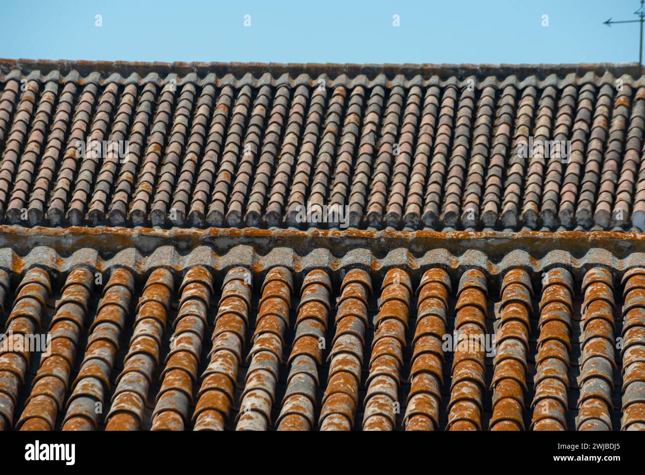 Traditional old Spanish ceramic roof tiles on a building ...