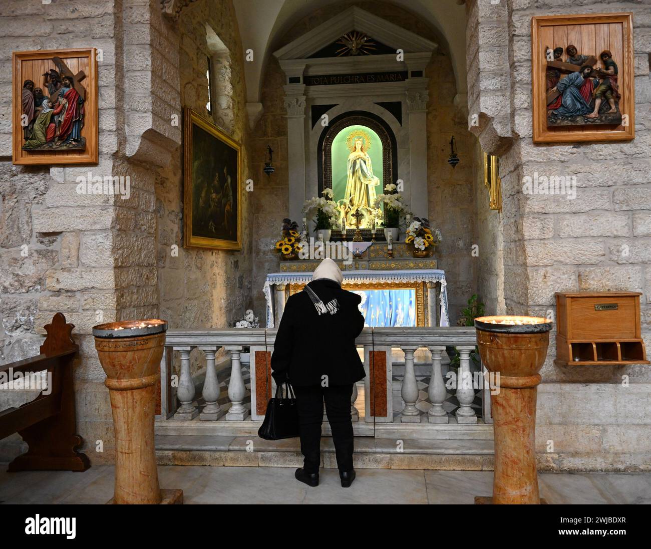 Bethlehem, West Bank. 14th Feb, 2024. A Palestinian Catholic prays ...
