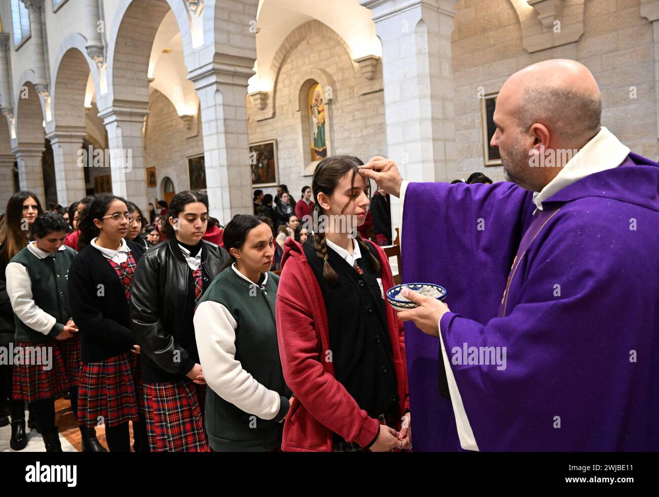 Palestinian Catholic schoolgirls receive ashes on their foreheads ...