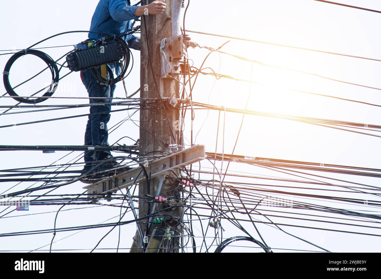 High voltage tower work for installing wires and equipment Stock Photo ...