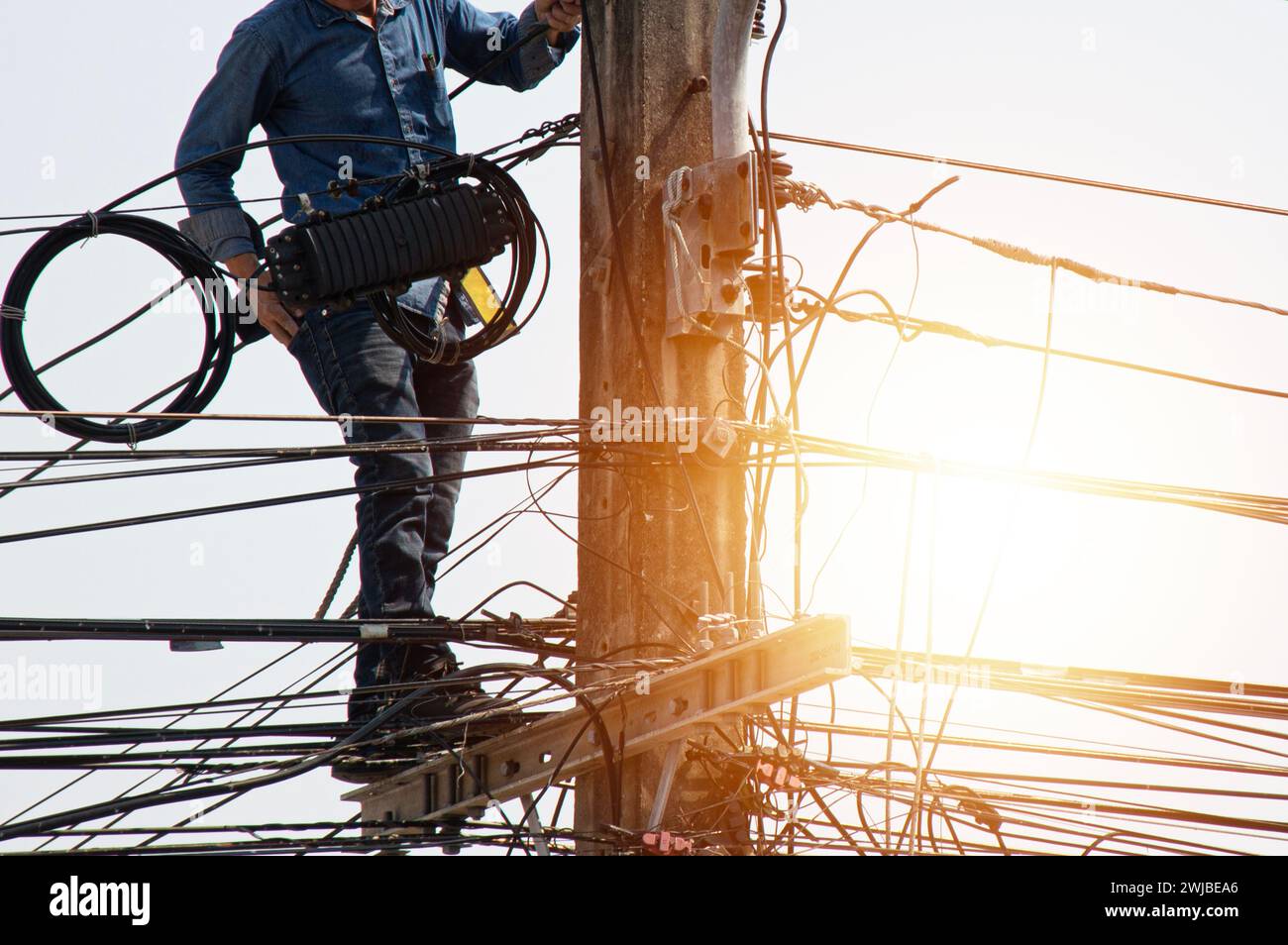 High voltage tower work for installing wires and equipment Stock Photo ...