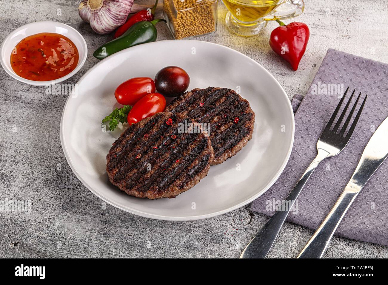 Grilled beef burger cutlet with sauce Stock Photo - Alamy