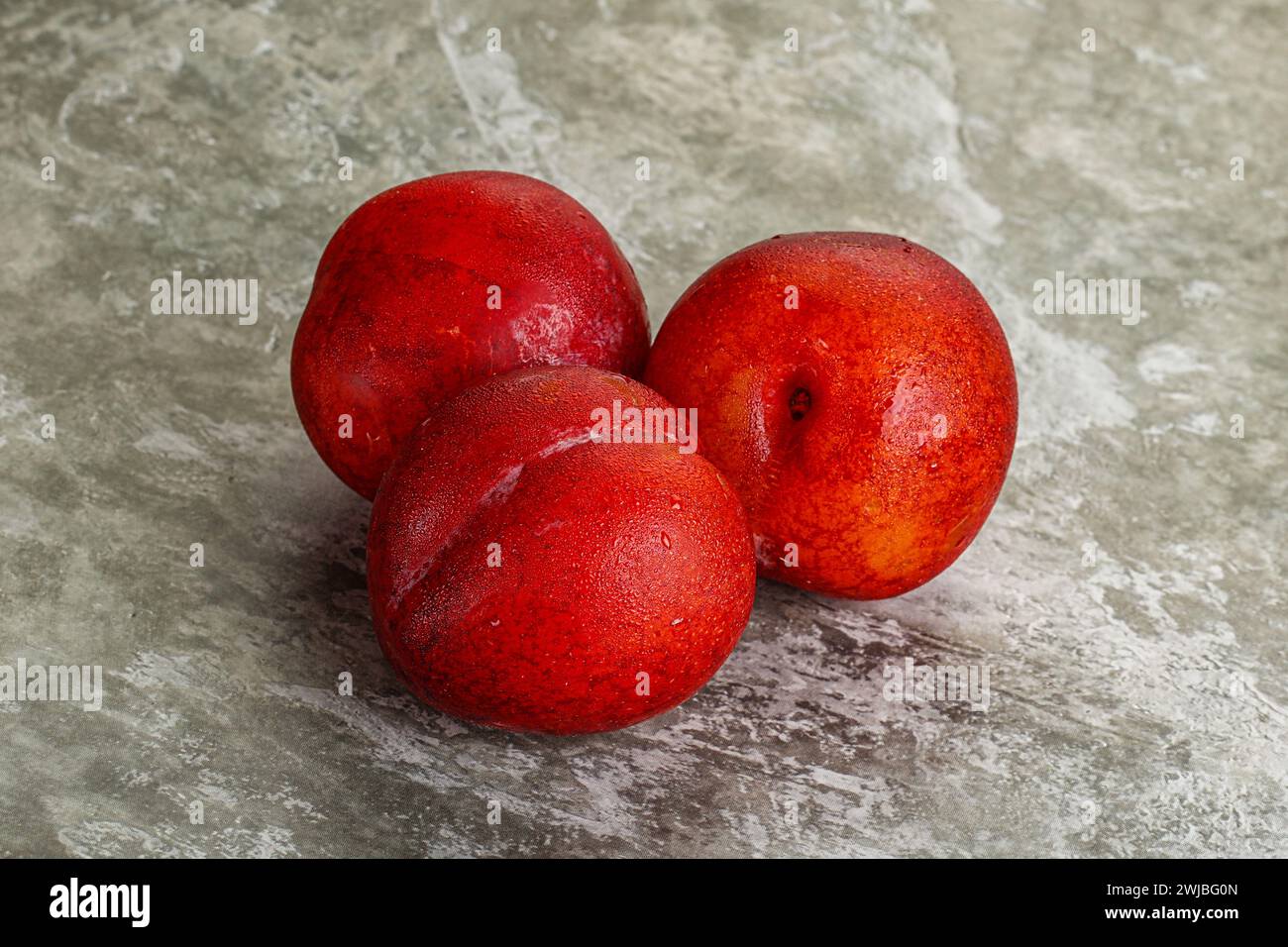 Ripe sweet juicy red plum heap Stock Photo - Alamy