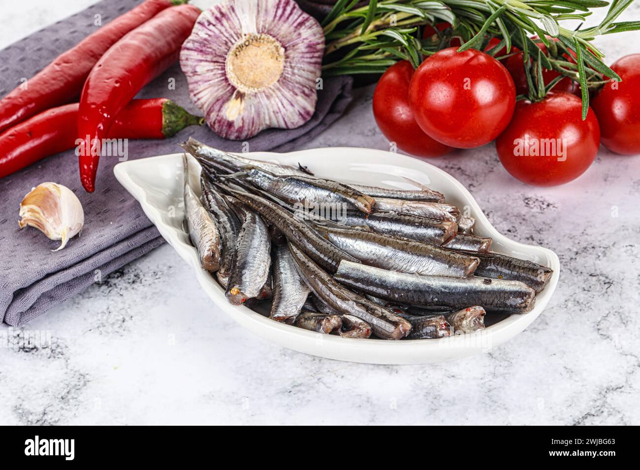Pickled anchovy fish in the plate Stock Photo - Alamy