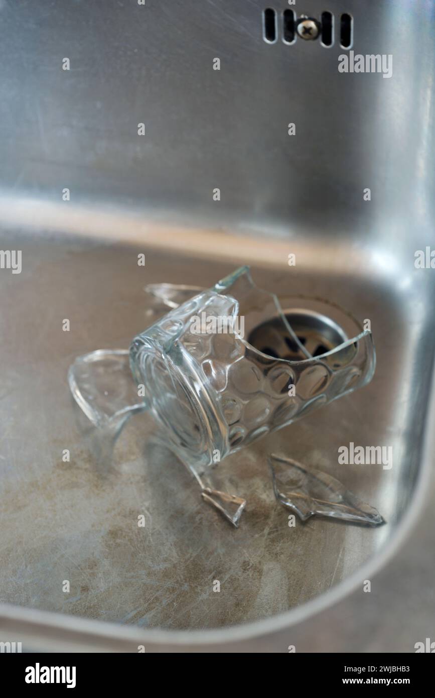 broken glass in a stainless steel sink Stock Photo - Alamy