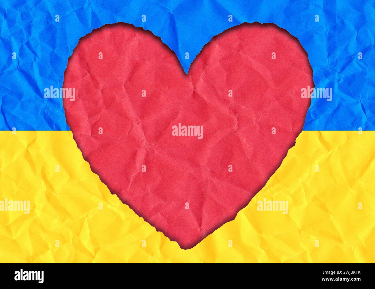 Scrap of paper in the shape of a heart in the colors of the Ukrainian ...