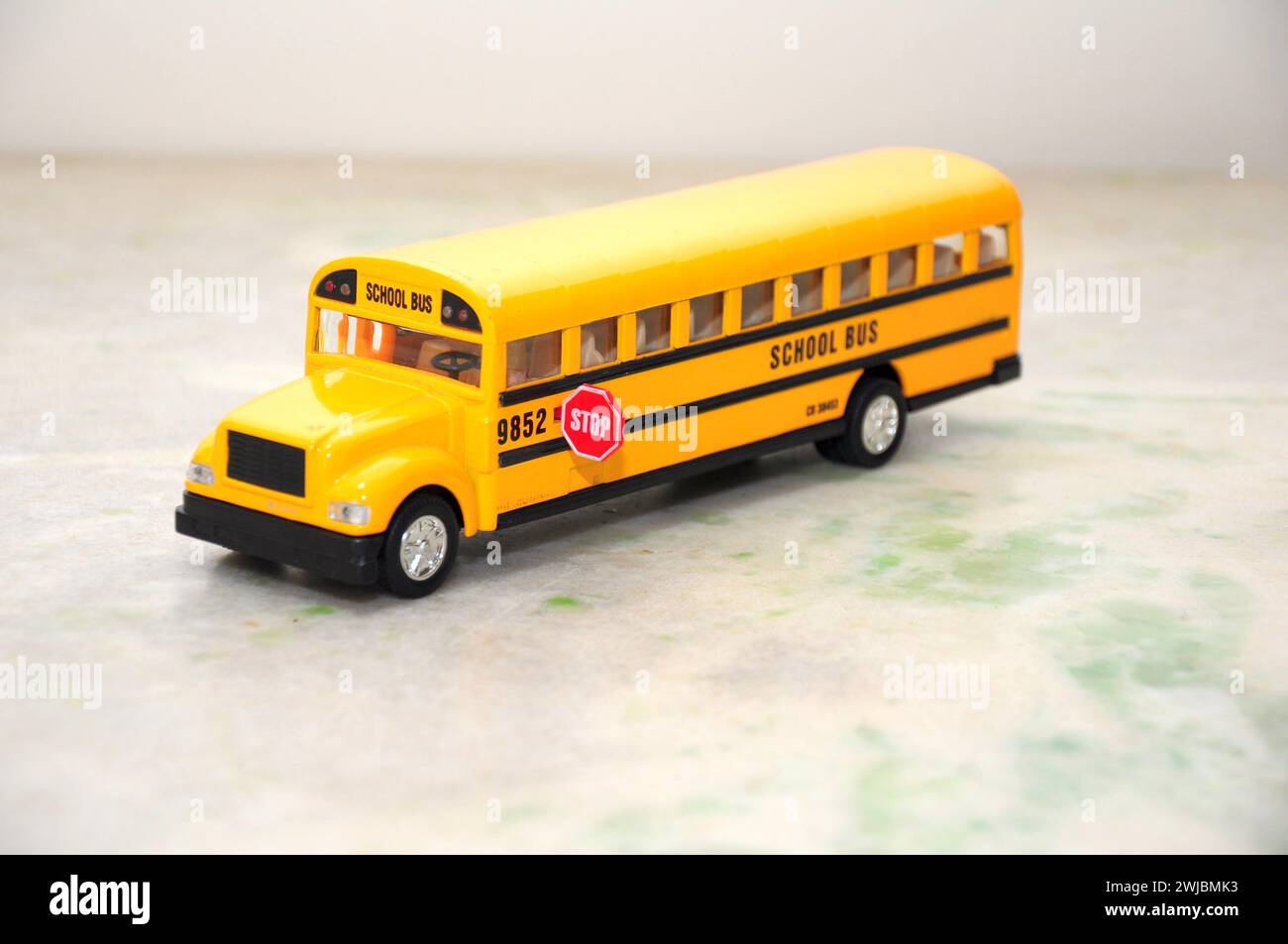 Miniature American school bus in standard yellow color with stop sign ...