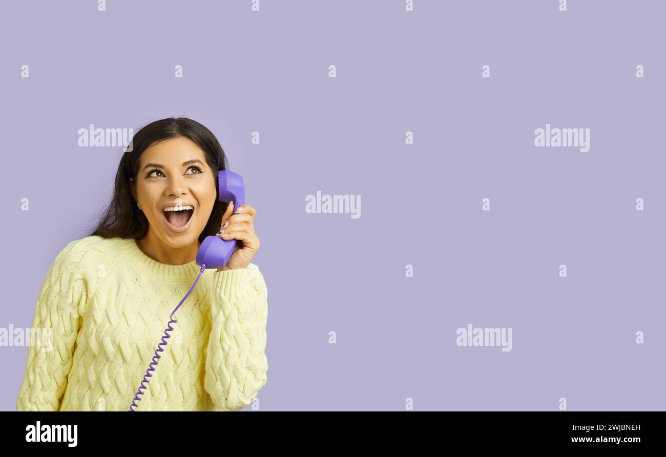 Pretty surprised woman is listening to the gossip on phone, she is ...