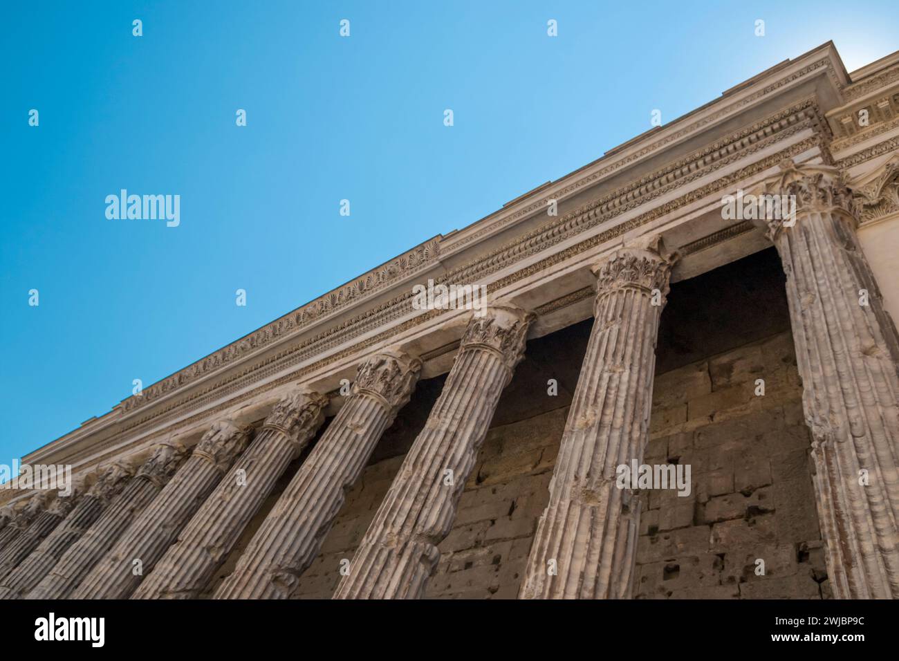 Ionian column capital, architectural detail. Low angle view of the ...
