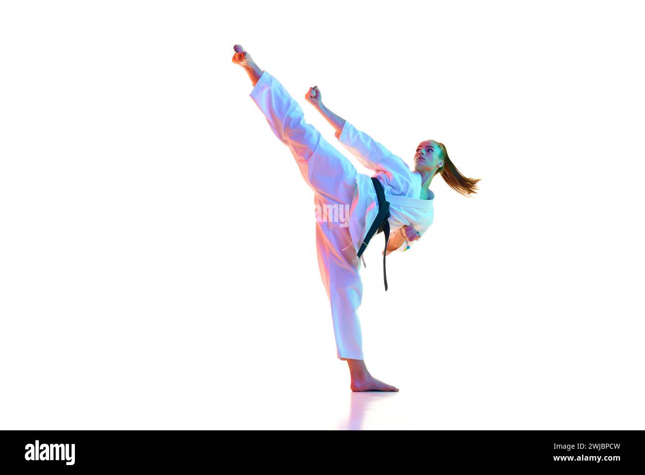 Master of Kung Fu, fighter show high kick pose in neon light, filter ...