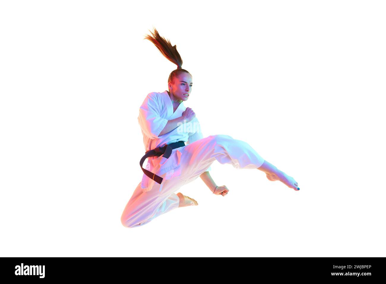 Young female karate fighter, karate master jumping, training in action ...