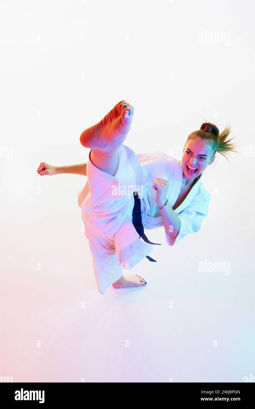 Top view portrait of female karate fighter, teacher performing high ...