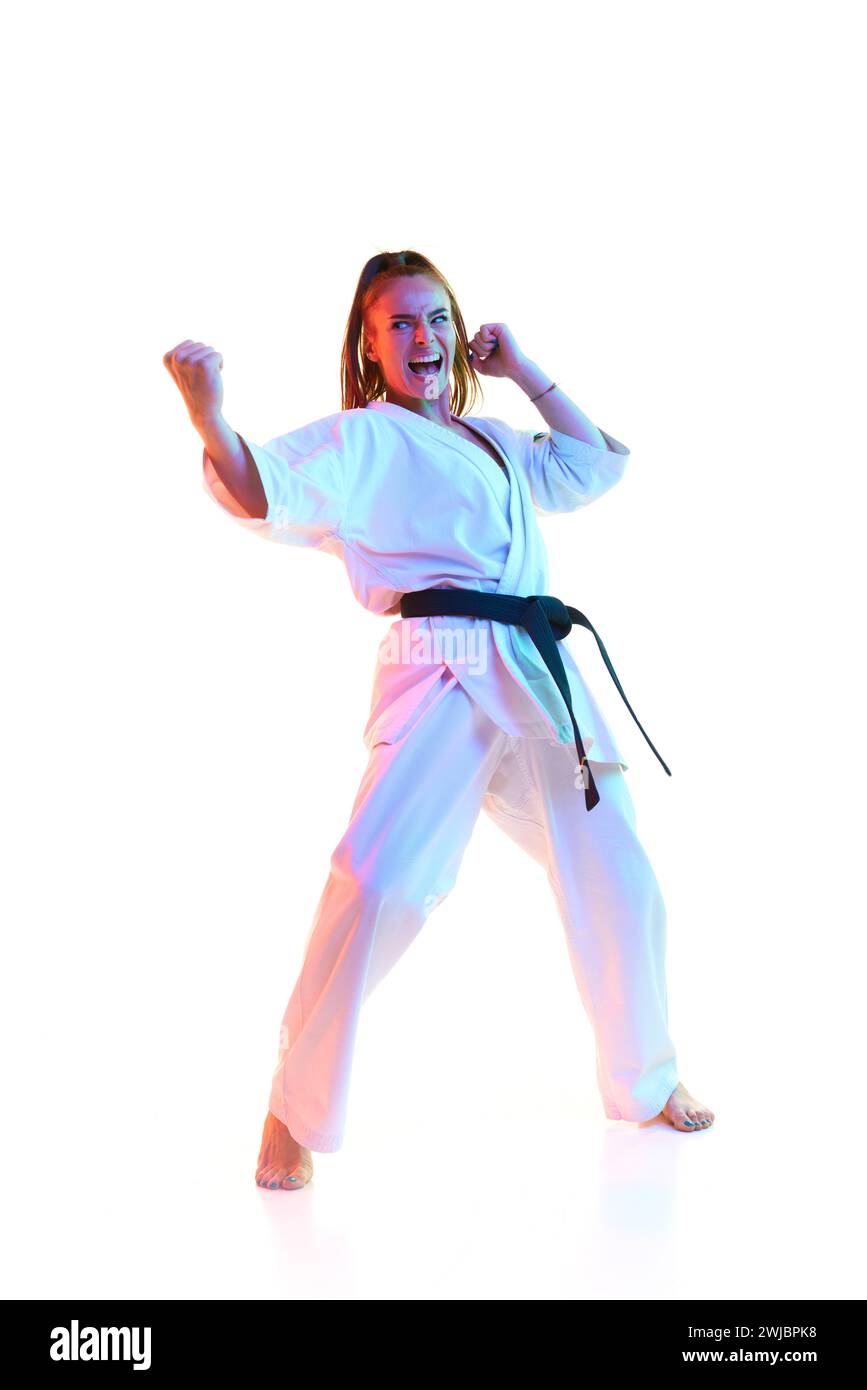 Top view portrait of woman, Taekwondo teacher performing high kick ...