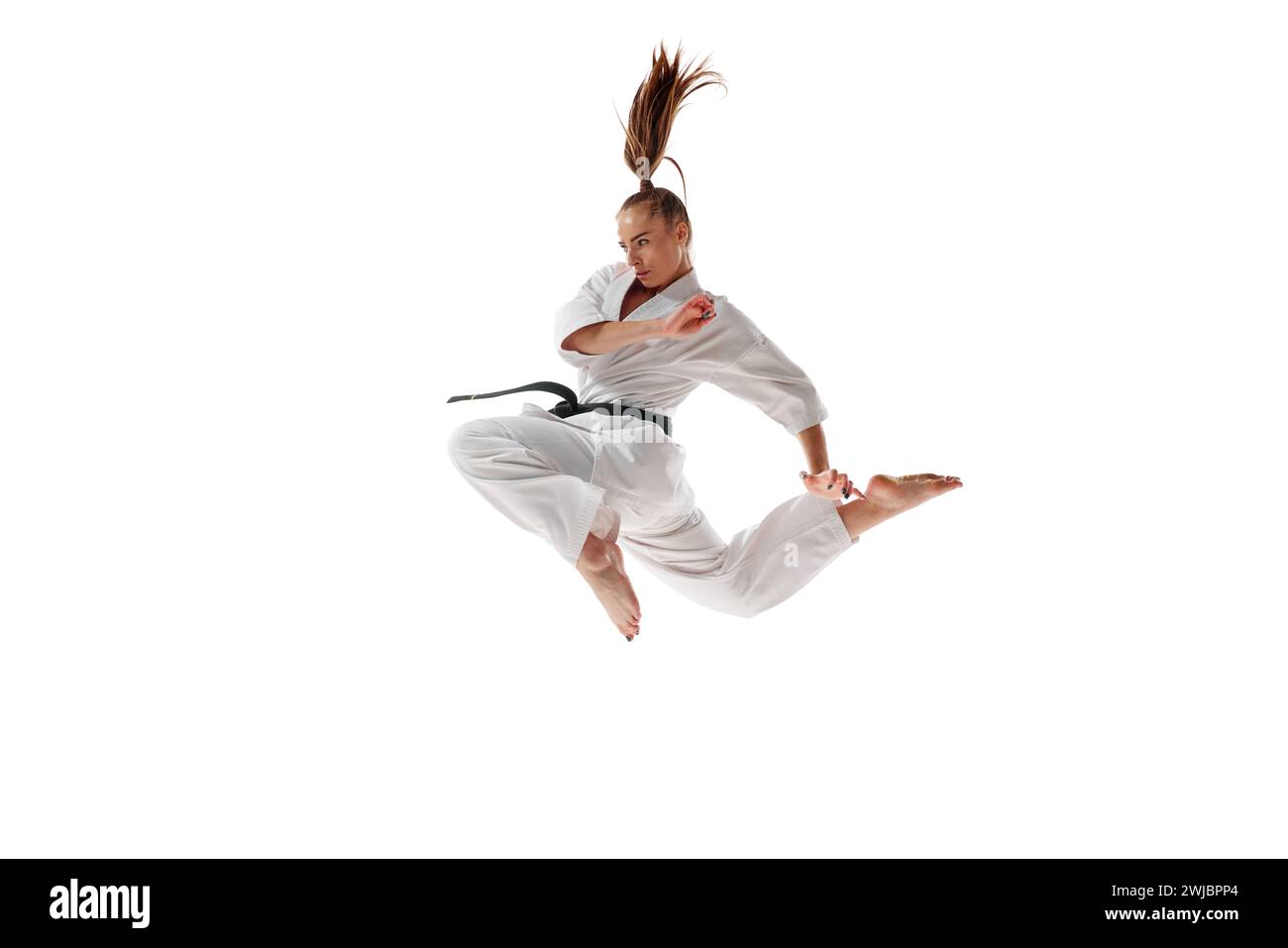 Female karate fighter jumping, training martial arts in action isolated ...