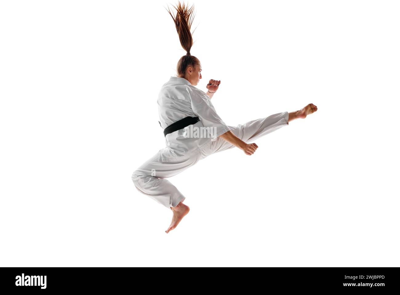 Rear view. Woman professional karate fighter jumping, training martial ...