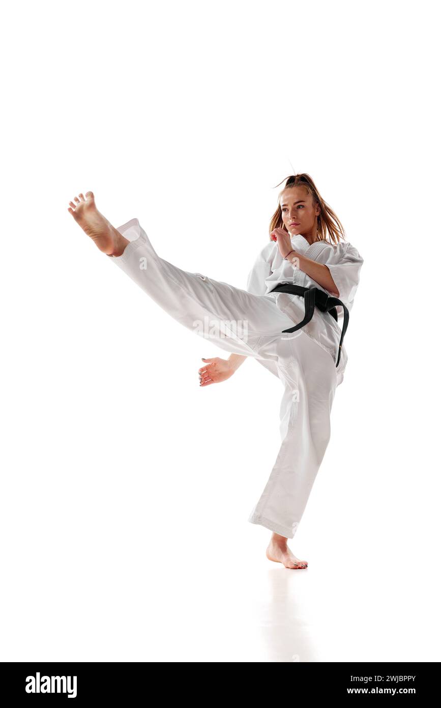 Rear view. Woman professional karate fighter with black belt performing ...