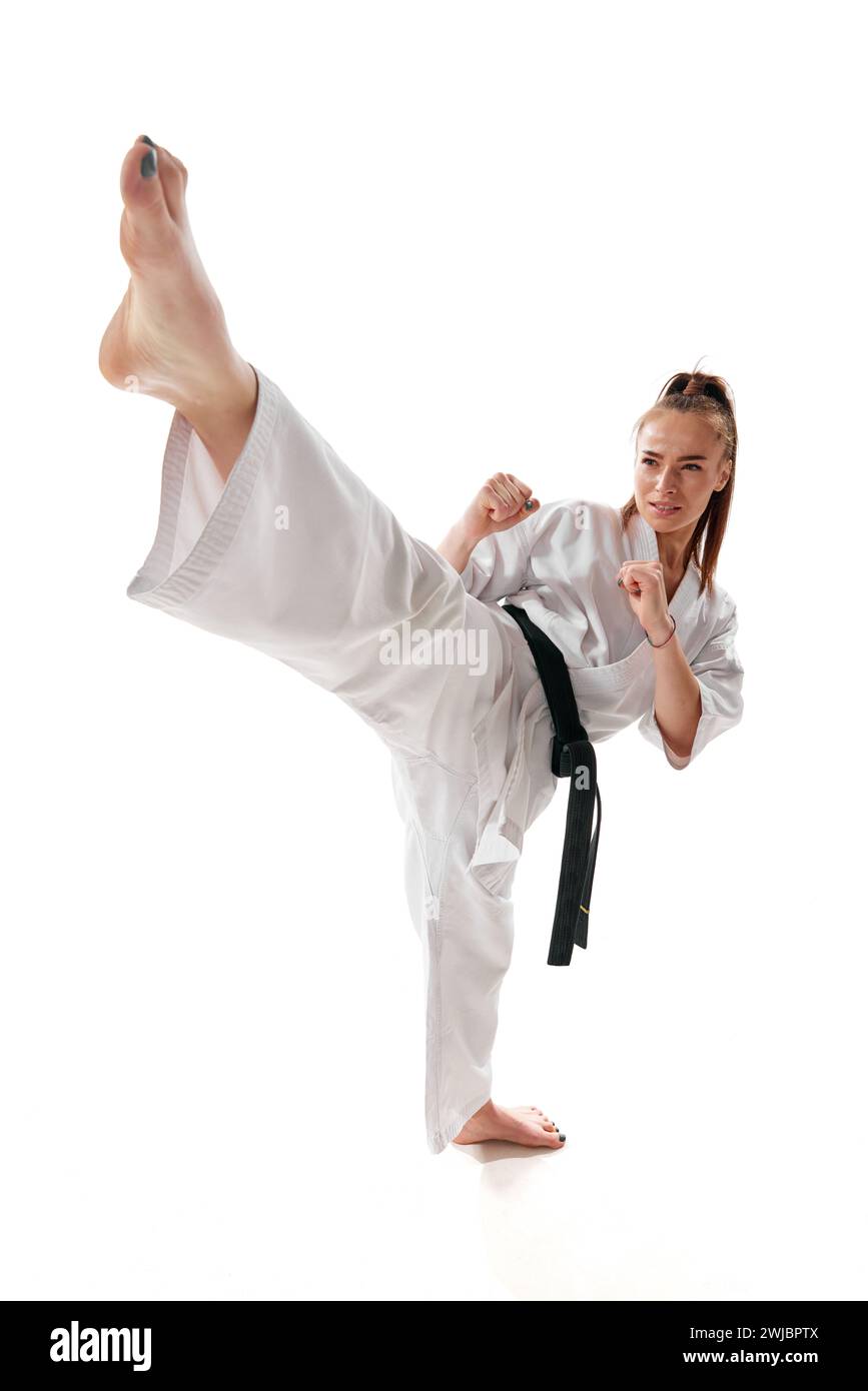 Master black belt Tae Kwon Do fighter in uniform show high kick pose ...