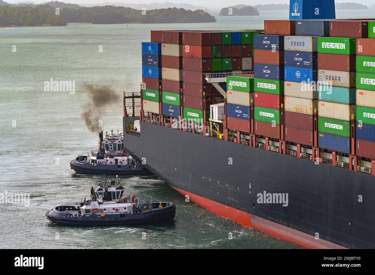 Colon, Panama - 22 January 2024: Tug boats assiting a large container ...