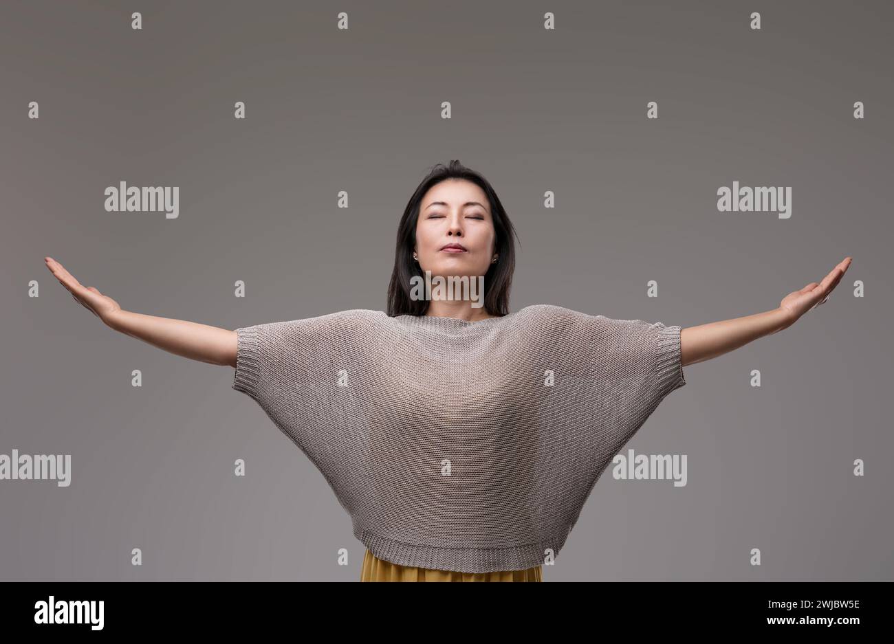 Her posture open and welcoming, she embodies tranquility and a ...